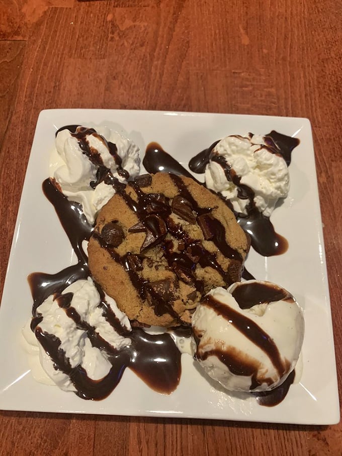A cookie that clearly went to finishing school. Four scoops of ice cream aren't excessive – they're necessary companions for that chocolate drizzle.