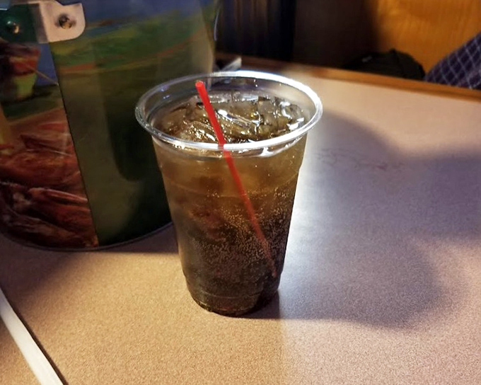 In a world of craft cocktails and artisanal everything, there's something profoundly honest about a simple soda with a red straw.
