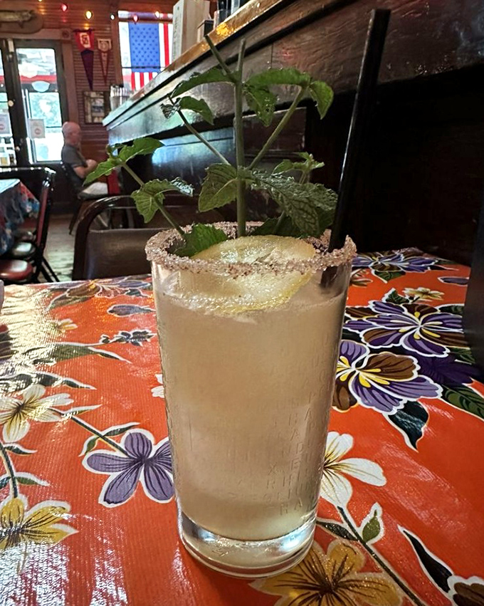 This isn't just a cocktail—it's a garden in a glass. The sugar rim and mint sprig transform a simple drink into something worth posting about.