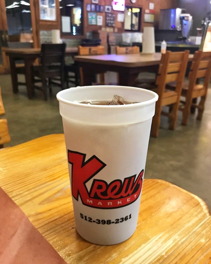 The cup says it all—Kreuz Market knows branding isn't just for cattle. That iconic red "K" is as recognizable to barbecue aficionados as golden arches are to everyone else.