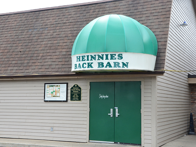 "Heinnies Back Barn" entrance with its distinctive green awning – like a portal to a world where prime rib rules supreme.