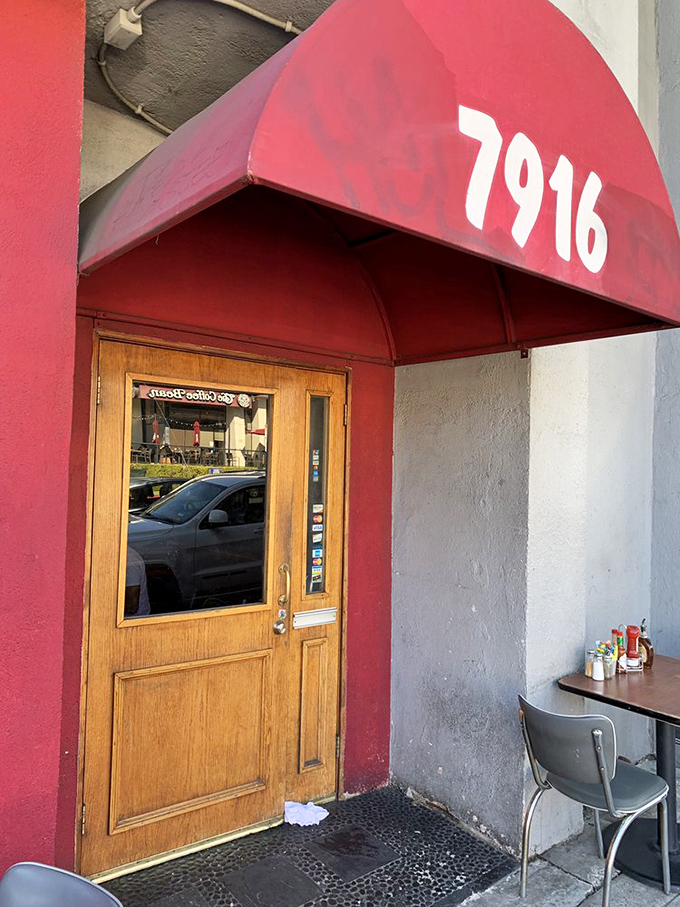 That wooden door with the red awning might as well be a portal to breakfast nirvana. The humble entrance belies the pancake paradise that awaits inside.