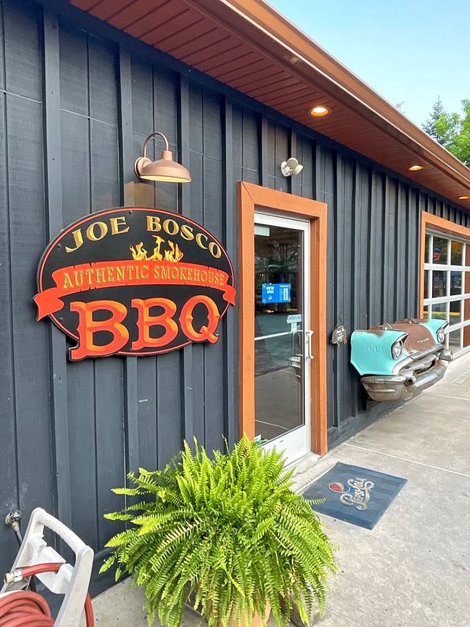 The entrance says it all—authentic smokehouse BBQ with vintage car flair. That fern isn't just decoration; it's trying to absorb BBQ knowledge.