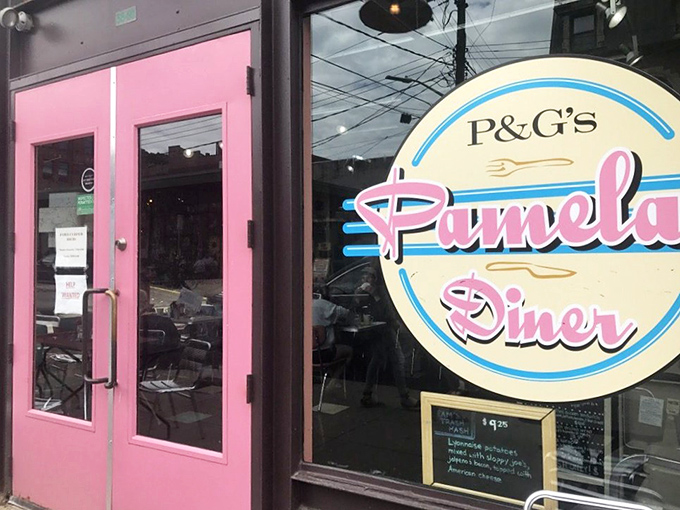 The pink door entrance whispers promises of breakfast bliss to all who dare to pull that handle.