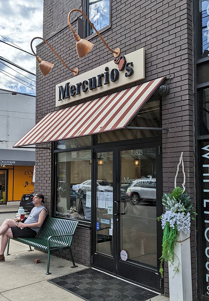 That moment when you realize you've found your new favorite spot. The bench outside Mercurio's—perfect for savoring anticipation or post-pizza contentment.