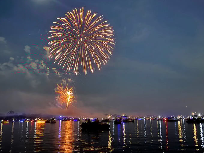 Nature's fireworks display meets human ingenuity. The lake transforms into a mirror, doubling the spectacle for twice the oohs and aahs.