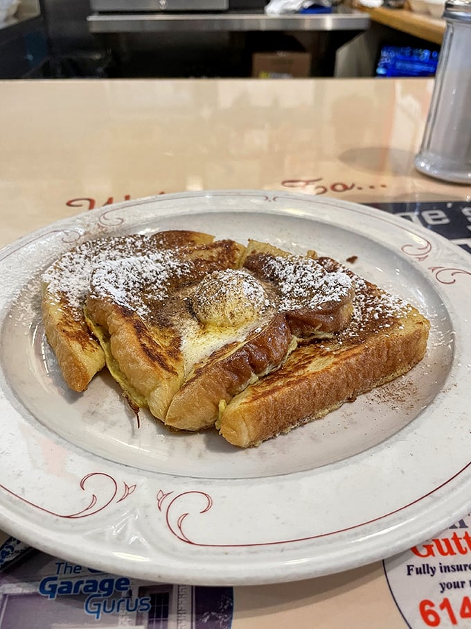 French toast that makes you wonder if your grandmother has been moonlighting in the kitchen—golden, crisp, and dusted with powdered nostalgia.