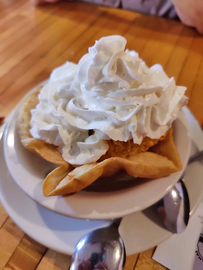 Fried ice cream: where hot meets cold in a dessert that defies physics and delights palates. That cloud of whipped cream is just showing off. 