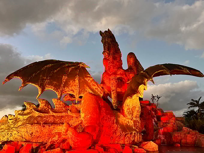 Fire and ice vibes as night falls. The dramatic lighting transforms bronze into something otherworldly—part sculpture, part light show.
