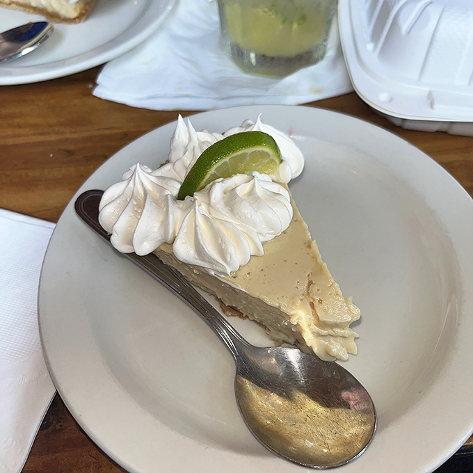 The key lime pie finale – creamy, tart perfection topped with clouds of whipped cream and that essential lime wedge for the Instagram crowd.