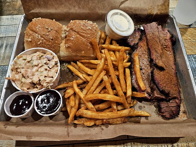 The BBQ platter arrives like a smoky tableau of carnivorous dreams—brisket, sides, and rolls arranged with the care of a meat Michelangelo.