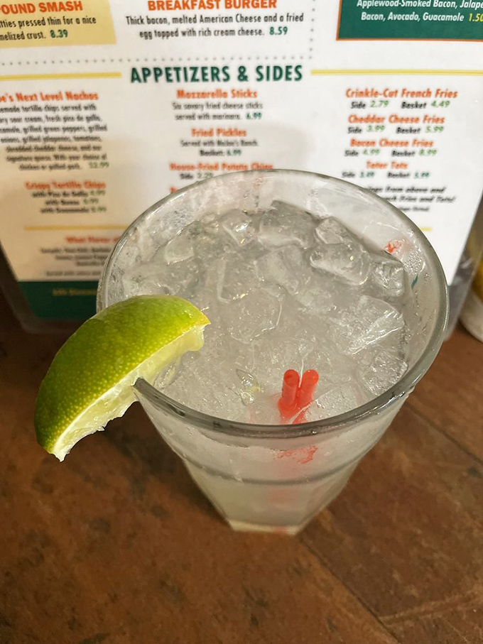 A proper lime wedge perched on the edge of a frosty glass—the sign of a drink mixed with care and attention to detail.