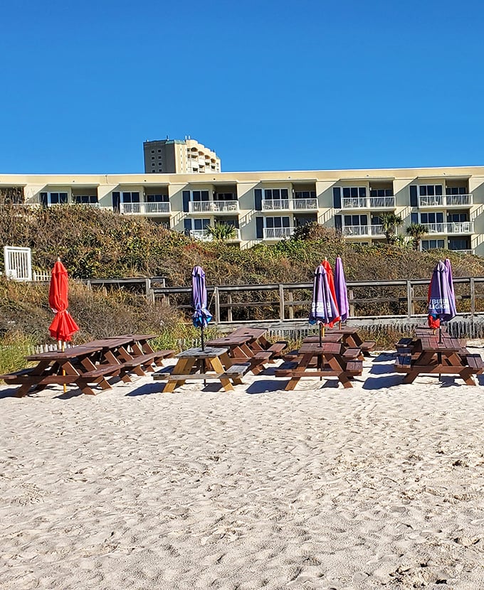 Beach picnic tables waiting for the day's first diners. Some people meditate for inner peace; others just need breakfast with this view.