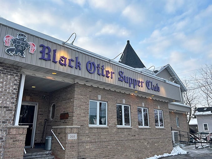 Winter can't dim the blue glow of supper club signage—a beacon of warmth for hungry travelers in the Wisconsin cold.