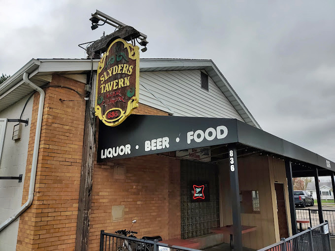 The vintage sign hanging proudly, announcing "LIQUOR • BEER • FOOD"—three simple words that sum up everything wonderful about the American tavern experience.