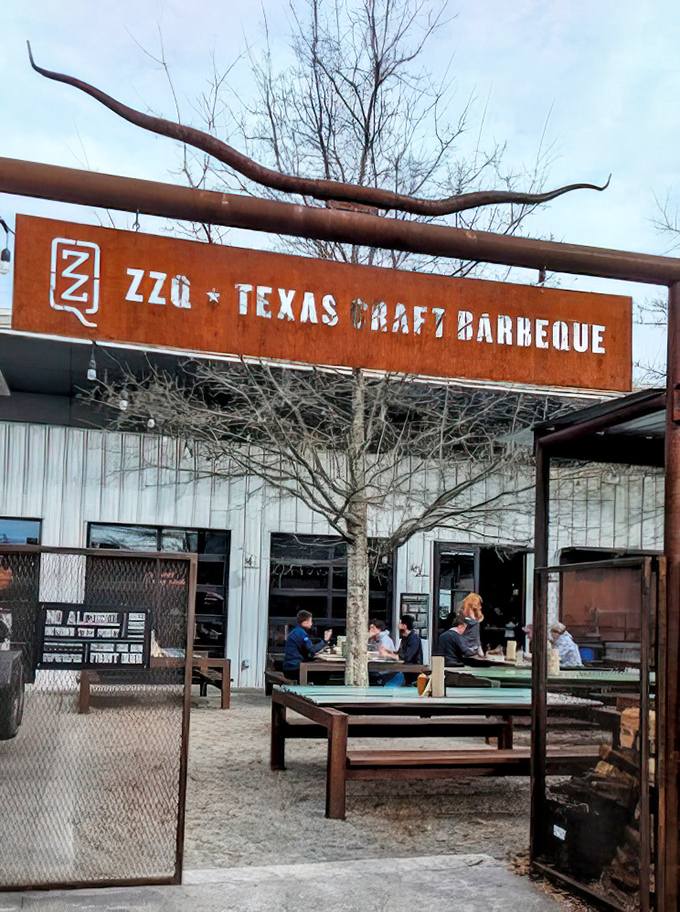 The rustic entrance sign stands like a portal to meat paradise. Those longhorns aren't just decoration—they're a warning: vegetarians proceed with caution.