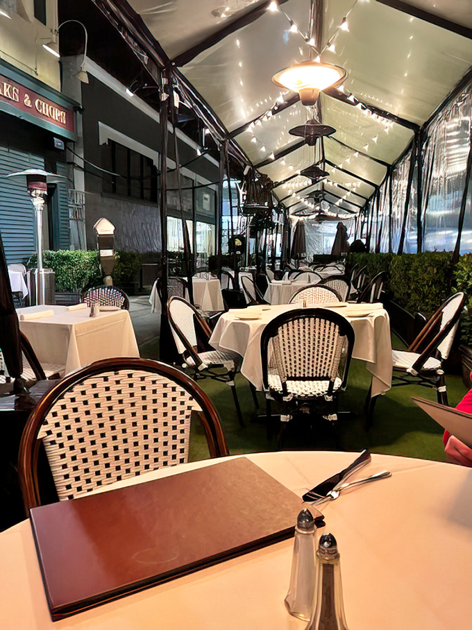 The covered outdoor dining area offers al fresco steakhouse magic—because sometimes you want your meat sweats with a side of fresh air.