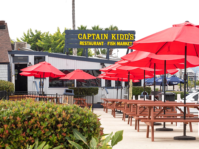 The outdoor seating area, with its cheerful red umbrellas, offers the quintessential SoCal dining experience—fresh air and fresher seafood.