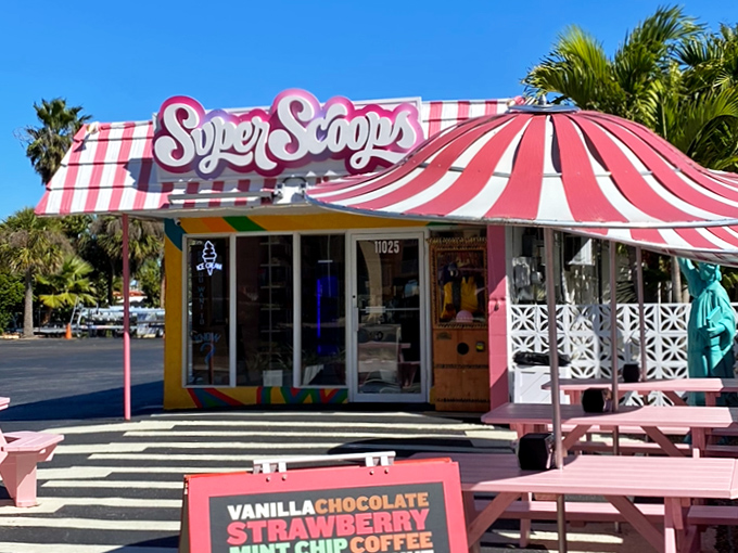 Pink picnic tables under palm trees create the quintessential Florida ice cream experience—just add sunscreen, flip-flops, and a complete disregard for calorie counting.