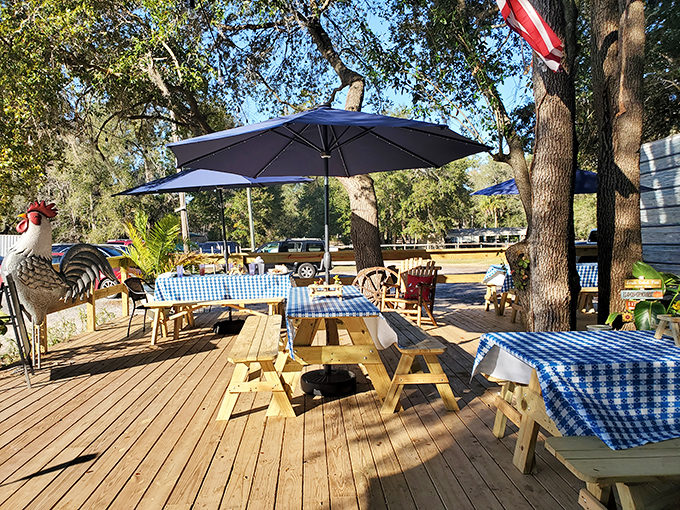 The outdoor dining deck under sprawling oak trees offers the quintessential Florida experience—enjoying comfort food while gentle breezes rustle through Spanish moss.