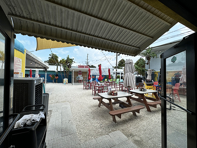 The outdoor dining area—where picnic tables, sea breezes, and string lights create the perfect setting for making memories between bites.