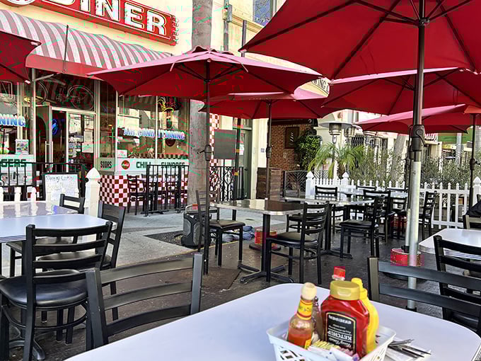 Outdoor seating under red umbrellas offers California sunshine with your meal—because some pleasures are too good to be contained indoors.