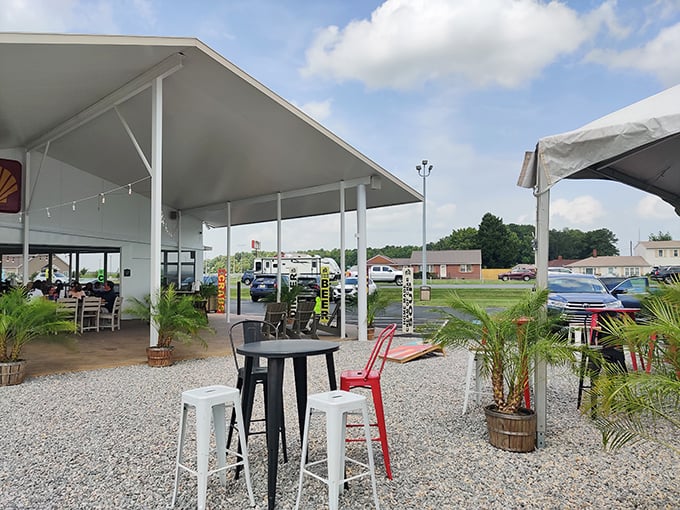 The outdoor dining area, with its casual seating and potted palms, offers a breezy alternative for those who prefer their seafood with a side of sunshine.