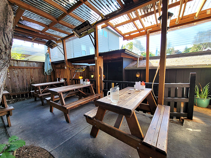 The outdoor patio—where picnic tables and overhead coverage create nature's perfect breakfast habitat for both sun-seekers and shade-dwellers alike.