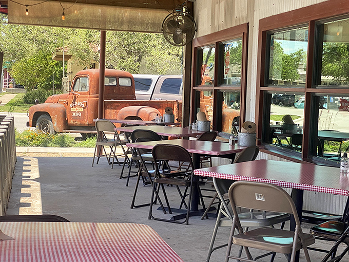 Outdoor seating with a view of a vintage truck—because good barbecue deserves good scenery and fresh Hill Country air.
