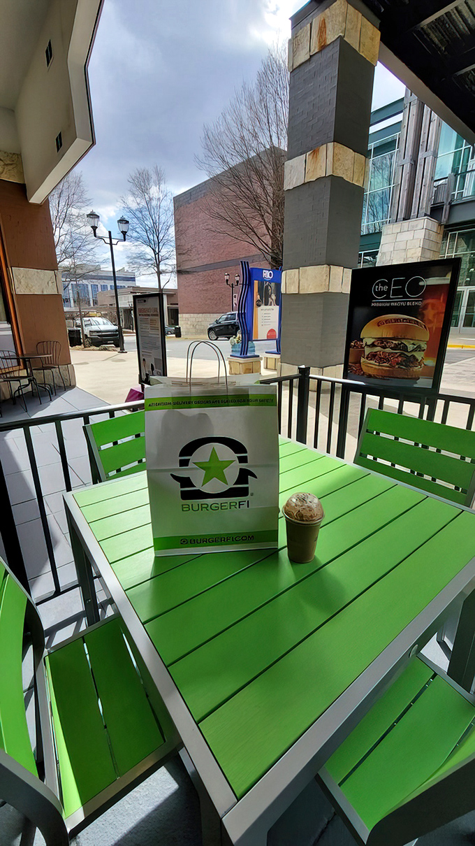 Outdoor seating with those signature green tables where good weather makes great burgers taste even better.