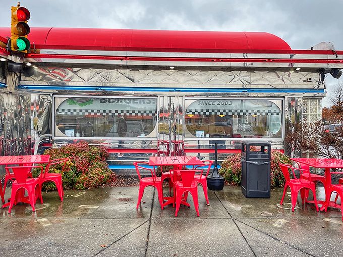 Even the outdoor seating area screams "classic Americana." Those red chairs aren't just furniture—they're front-row seats to the theater of diner life.