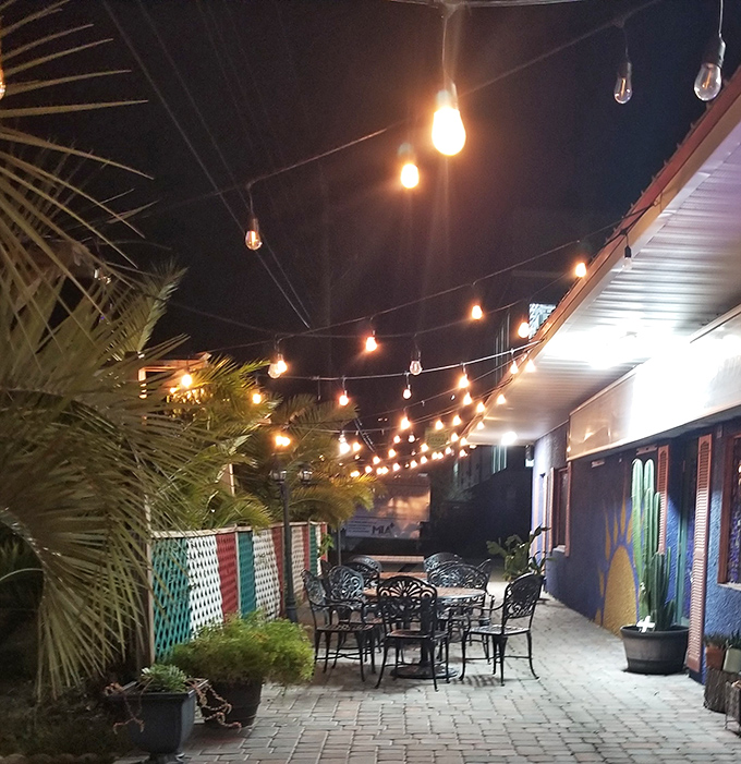 As night falls, the patio transforms into a twinkling oasis. Those string lights aren't just illumination—they're the stars of a Florida night reimagined as a Mexican courtyard.