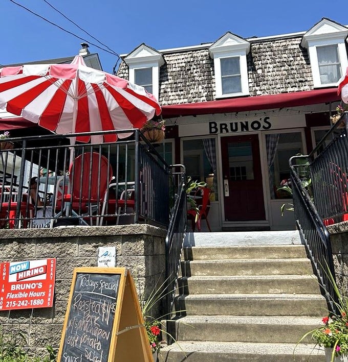 Bruno's exterior view showcases its perfect blend of homey charm and neighborhood fixture status. Those red and white umbrellas aren't just decorative – they're beacons of breakfast hope.