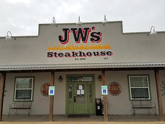 J W's Steakhouse stands proudly against the Texas sky, a beacon of hope for hungry travelers and locals alike.