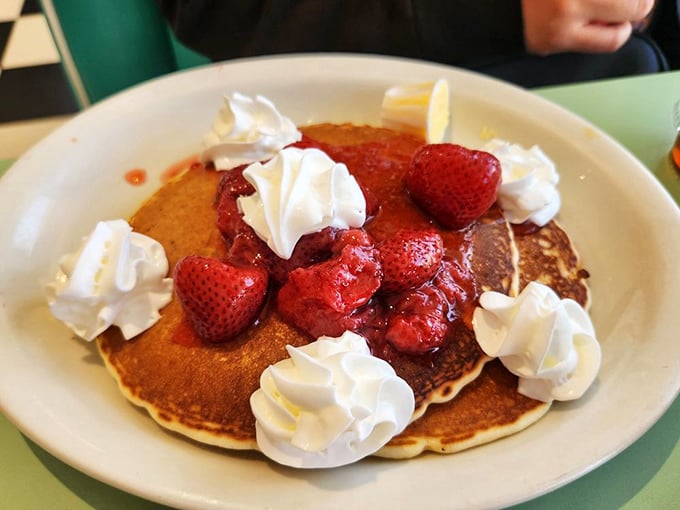 Pancakes topped with fresh berries and whipped cream—proof that breakfast can double as dessert. The perfect excuse to start your day with something sweet.