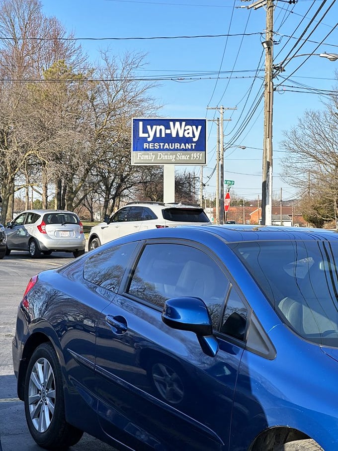 A parking lot that's rarely empty for good reason. Cars gather here like pilgrims at a culinary shrine, drawn by the siren call of homemade pie.