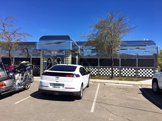 The parking lot tells its own story—motorcycles and cars gathered like hungry pilgrims at a chrome-plated shrine to American comfort food.