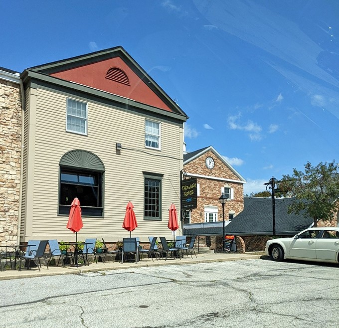 Outdoor seating with cheerful red umbrellas offers a more subdued alternative to the artistic explosion inside. Sometimes sunshine is all the decoration needed.