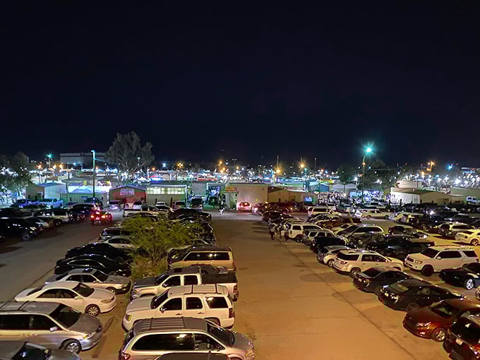 From this bird's-eye view, the swap meet glows like its own little city, a constellation of lights drawing bargain hunters from miles around.
