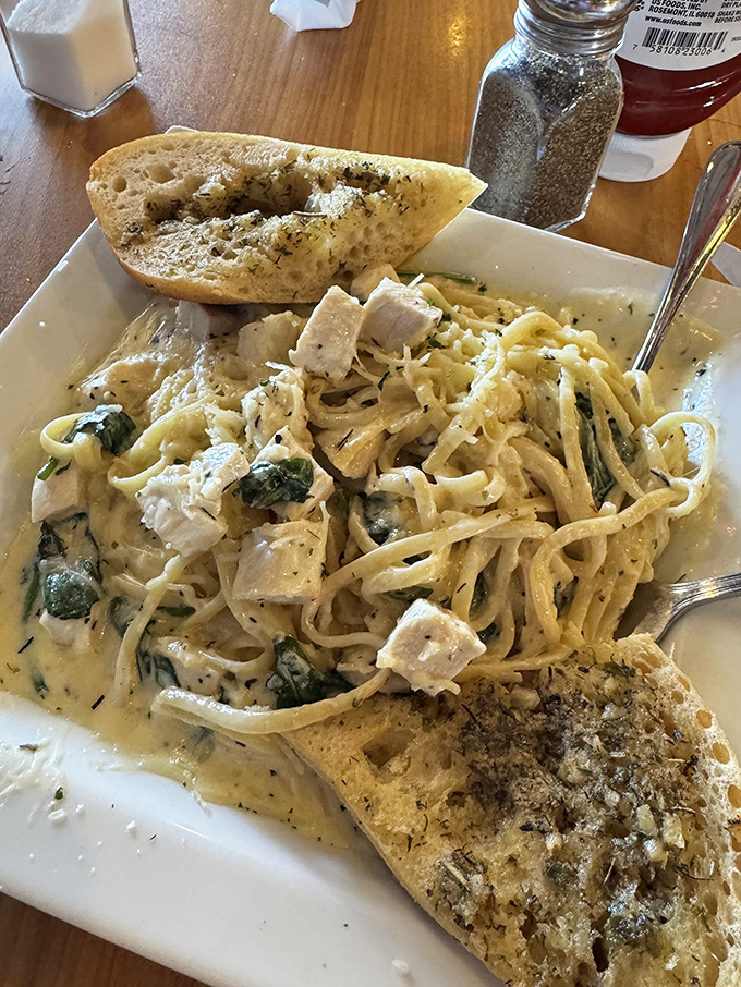 Pasta that would make an Italian opera singer hit high notes of approval—creamy, comforting, and served with garlic bread for sauce-sopping perfection.