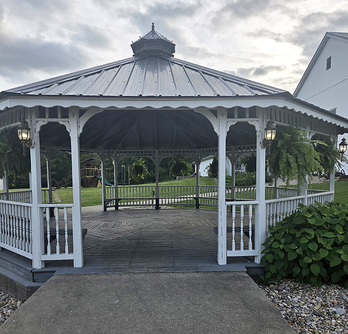 The white gazebo stands like a serene island amid the grounds, offering a peaceful spot for reflection—or digestion after that third slice of pie. 