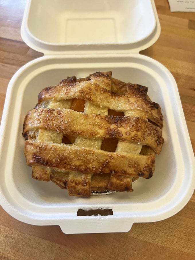 Lattice-top pie that would make your grandmother simultaneously proud and jealous. The to-go container is optimistic—this won't make it home.