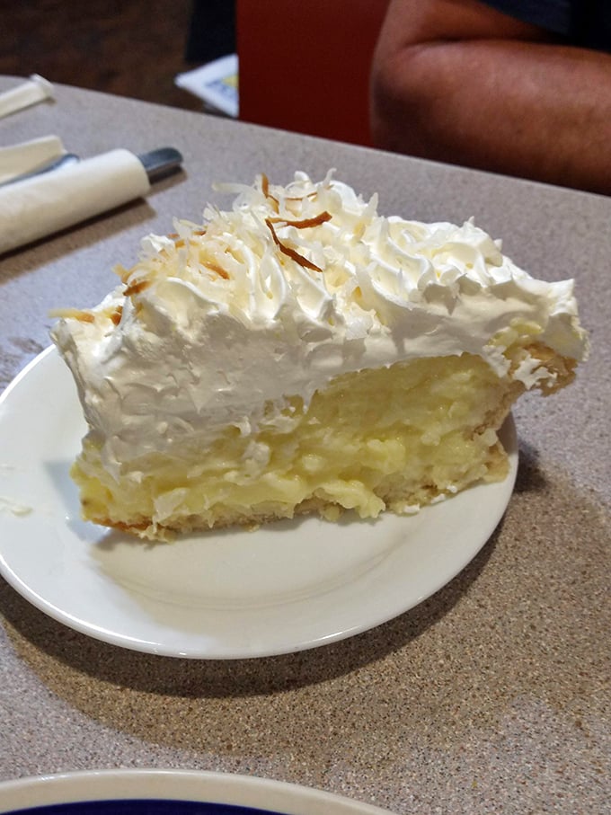 Coconut cream pie with a mile-high meringue—the kind of dessert that makes you seriously consider ordering a second slice before finishing the first.