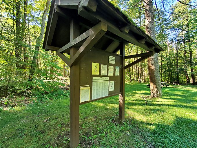 Information kiosk that doesn't try to compete with its surroundings. Sometimes the best technology is a wooden board with a roof – no updates required.