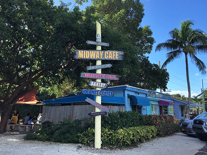 This directional sign doesn't just tell you where to go—it announces all the delicious possibilities awaiting at this colorful corner of paradise.
