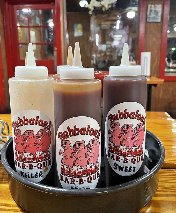 The holy trinity of sauces—each squeeze bottle a different path to flavor enlightenment. Choose your adventure or try all three. No judgment here.