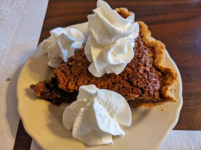 Shoofly pie topped with clouds of whipped cream – molasses-rich, sticky-sweet Pennsylvania Dutch tradition that has converted dessert skeptics for generations.