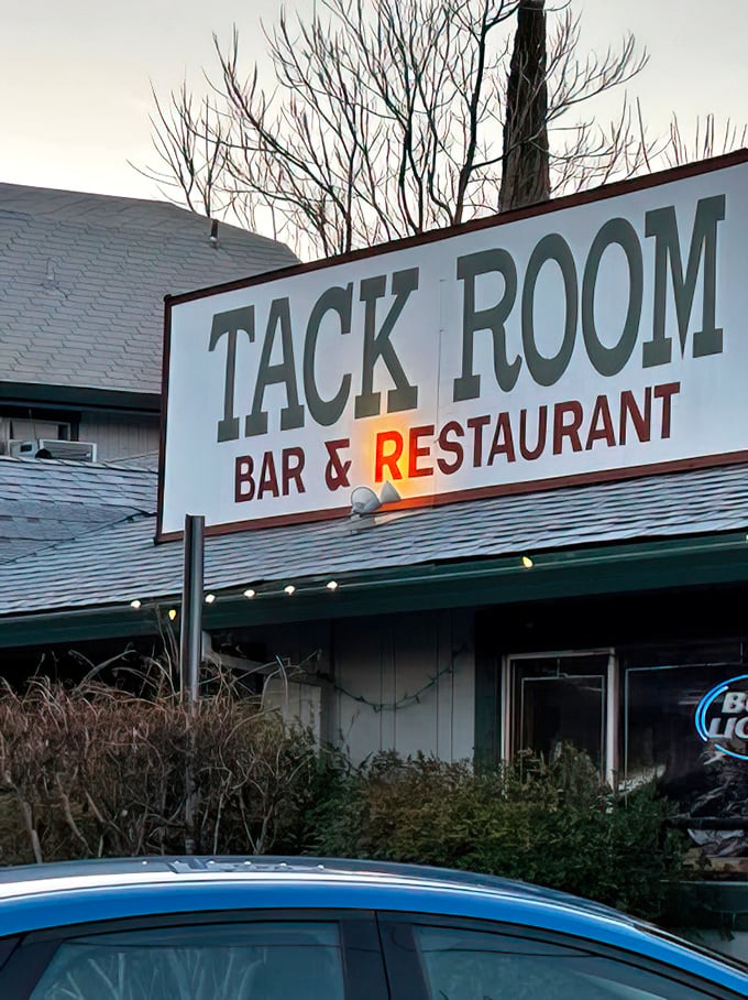 As evening falls, the Tack Room sign glows with promise—a beacon for hungry travelers and locals alike seeking honest-to-goodness deliciousness.