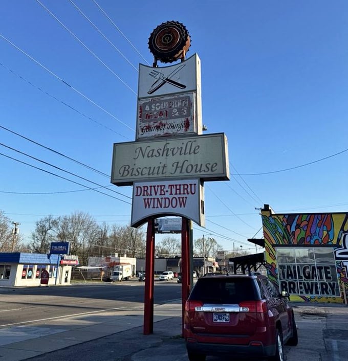 A roadside beacon of breakfast hope—the Nashville Biscuit House sign stands tall, guiding hungry travelers to their morning salvation.