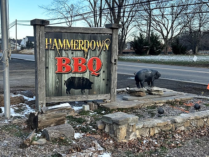 The roadside sign announces your arrival at meat paradise. That pig statue isn't decoration—it's a greeter, a mascot, and a promise of deliciousness to come.
